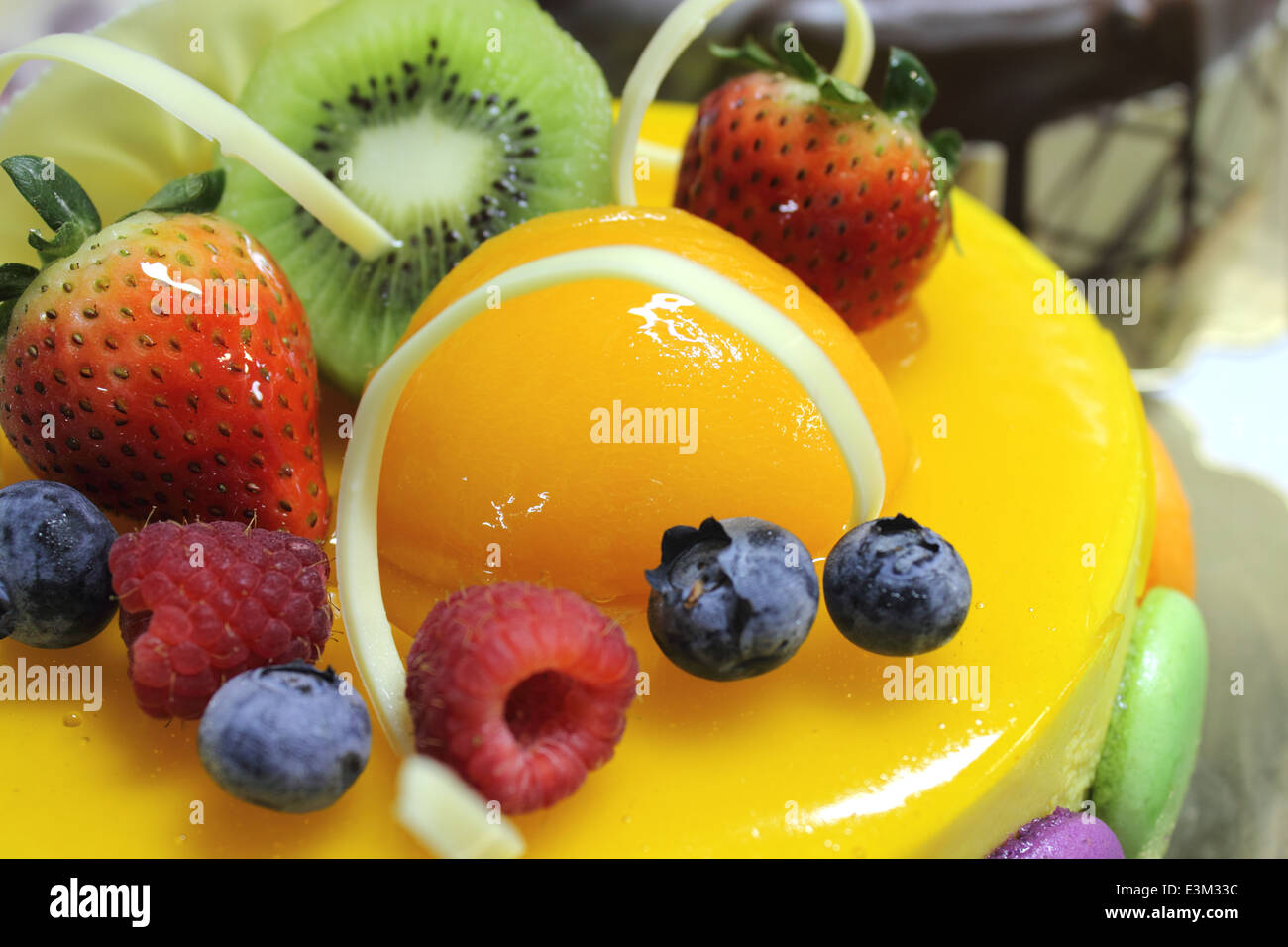 A mousse cake and topped with fresh fruit Stock Photo - Alamy