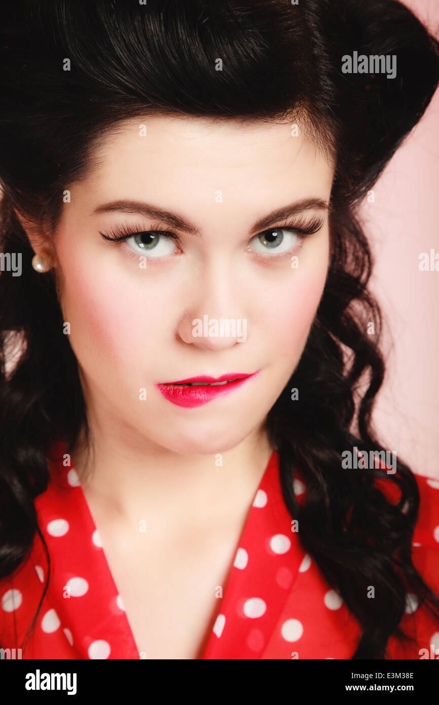 Retro style. Portrait of stylish woman biting her lips on pink ...