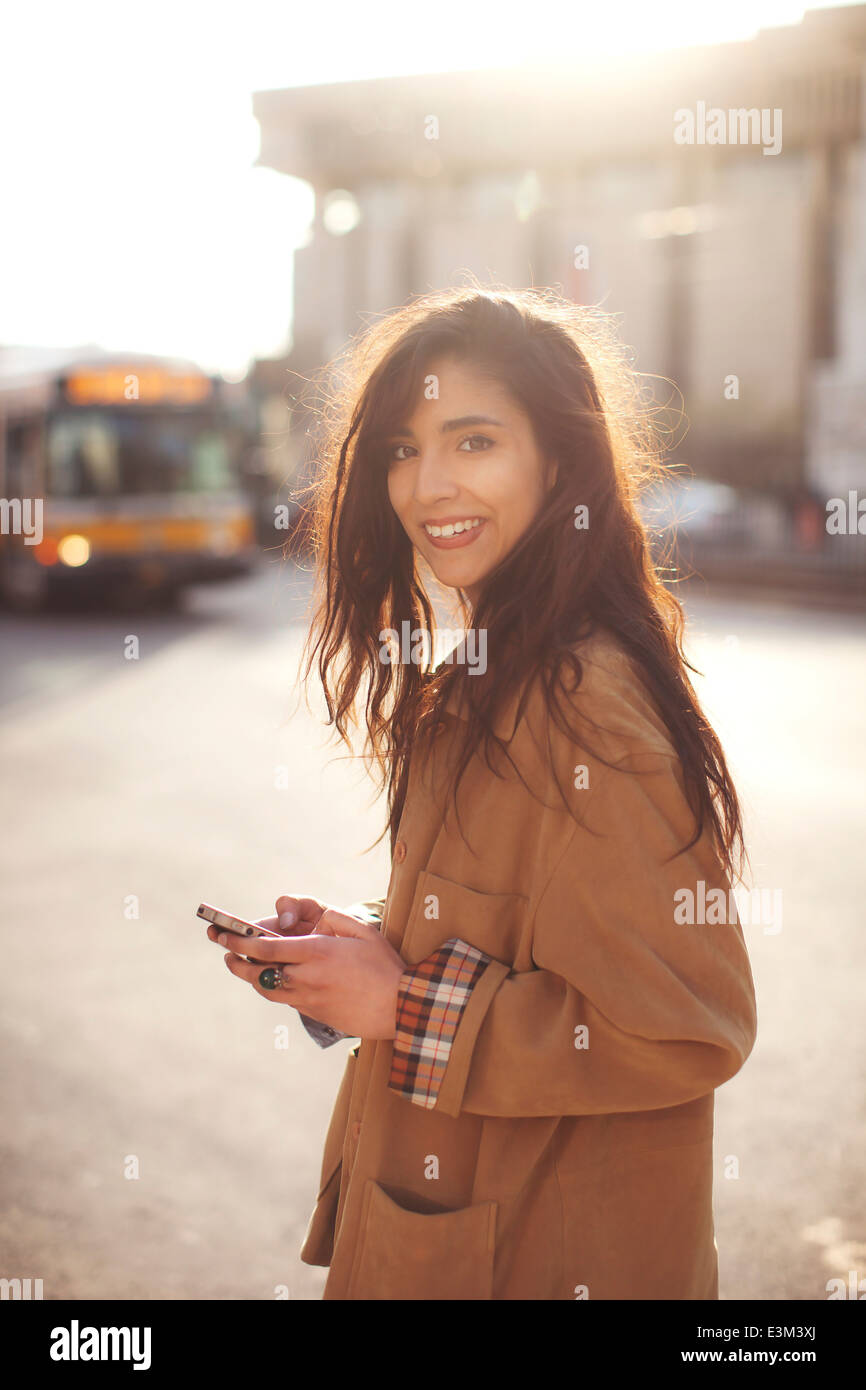 Portrait of young woman using cell phone Stock Photo - Alamy