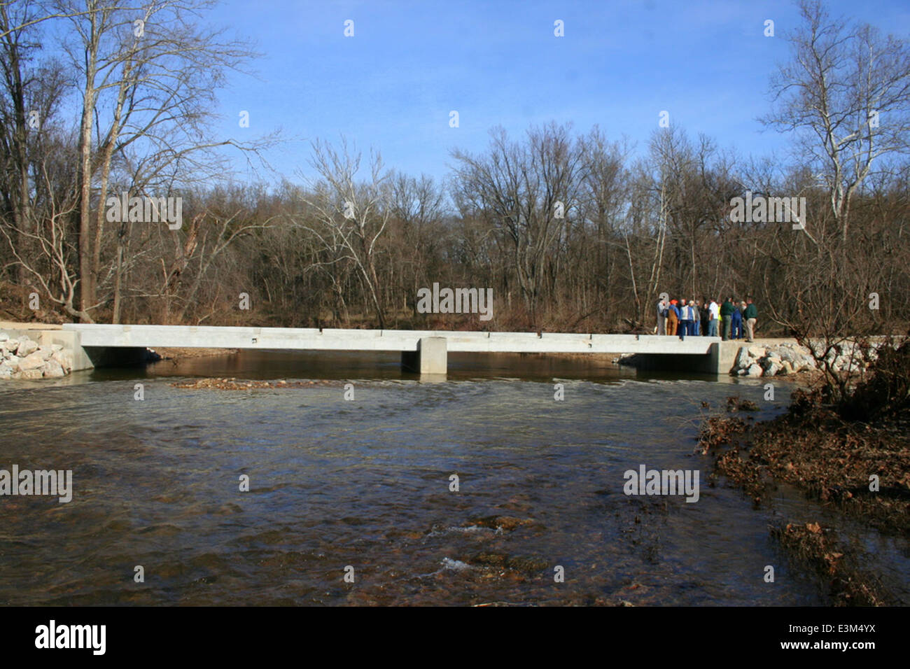 A downstream view of a bridge over a river, showcasing the surrounding ...