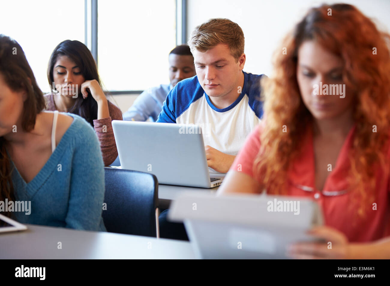 Male University Student Using Laptop In Classroom Stock Photo - Alamy