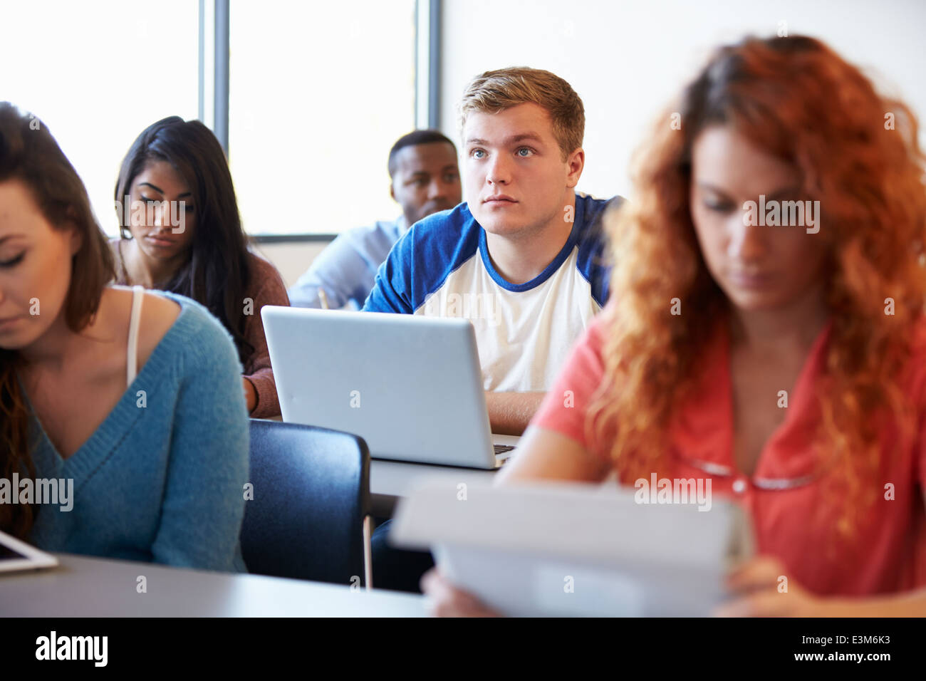 Male University Student Using Laptop In Classroom Stock Photo - Alamy
