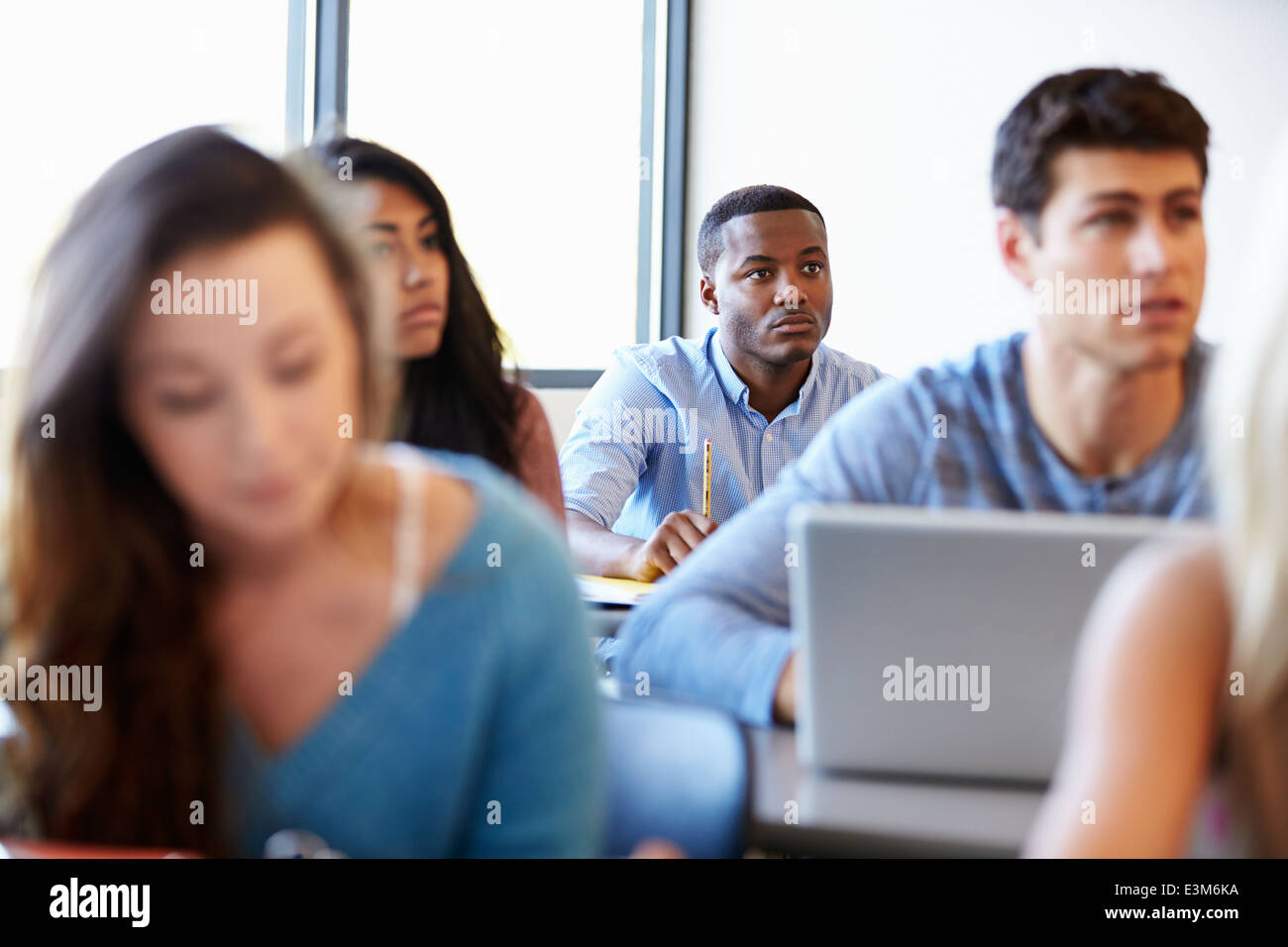 Male University Student Using Laptop In Classroom Stock Photo - Alamy