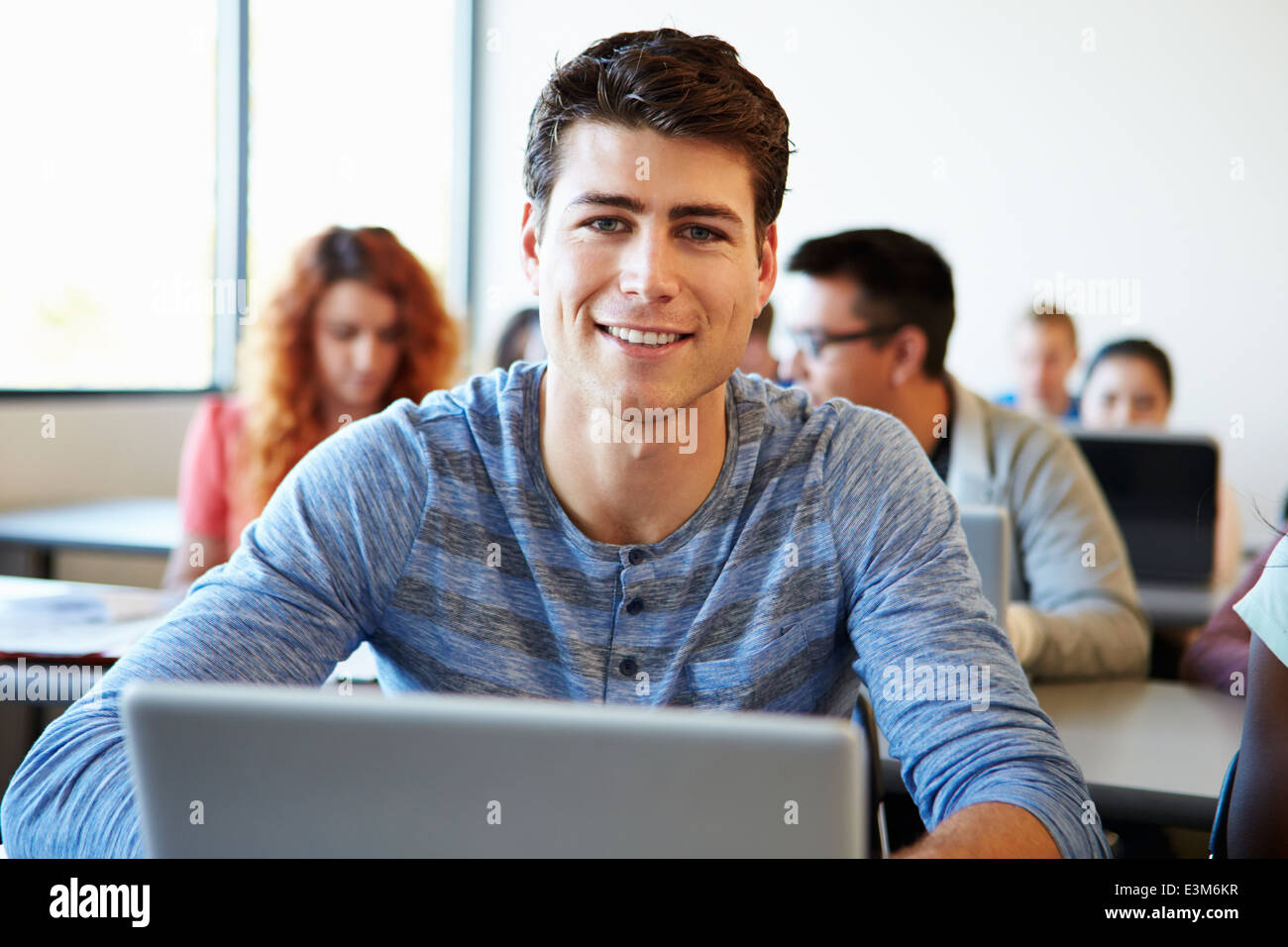 Male University Student Using Laptop In Classroom Stock Photo - Alamy