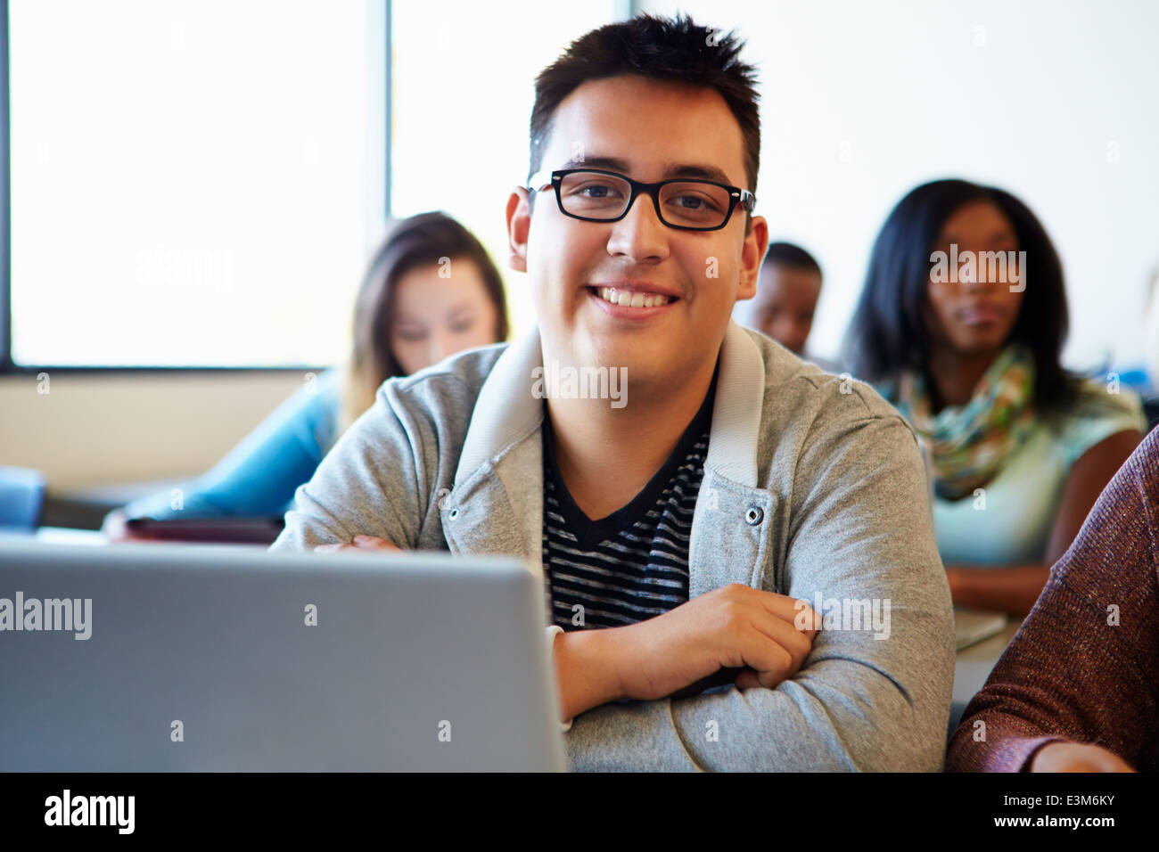 Male University Student Using Laptop In Classroom Stock Photo - Alamy