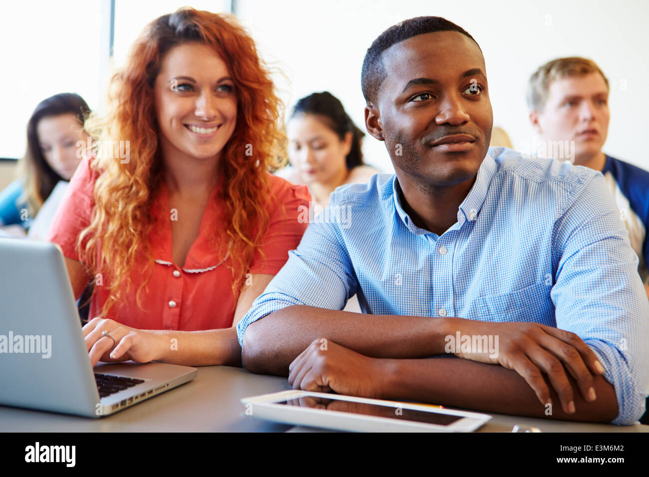 University Students Using Digital Tablet And Laptop In Class Stock ...