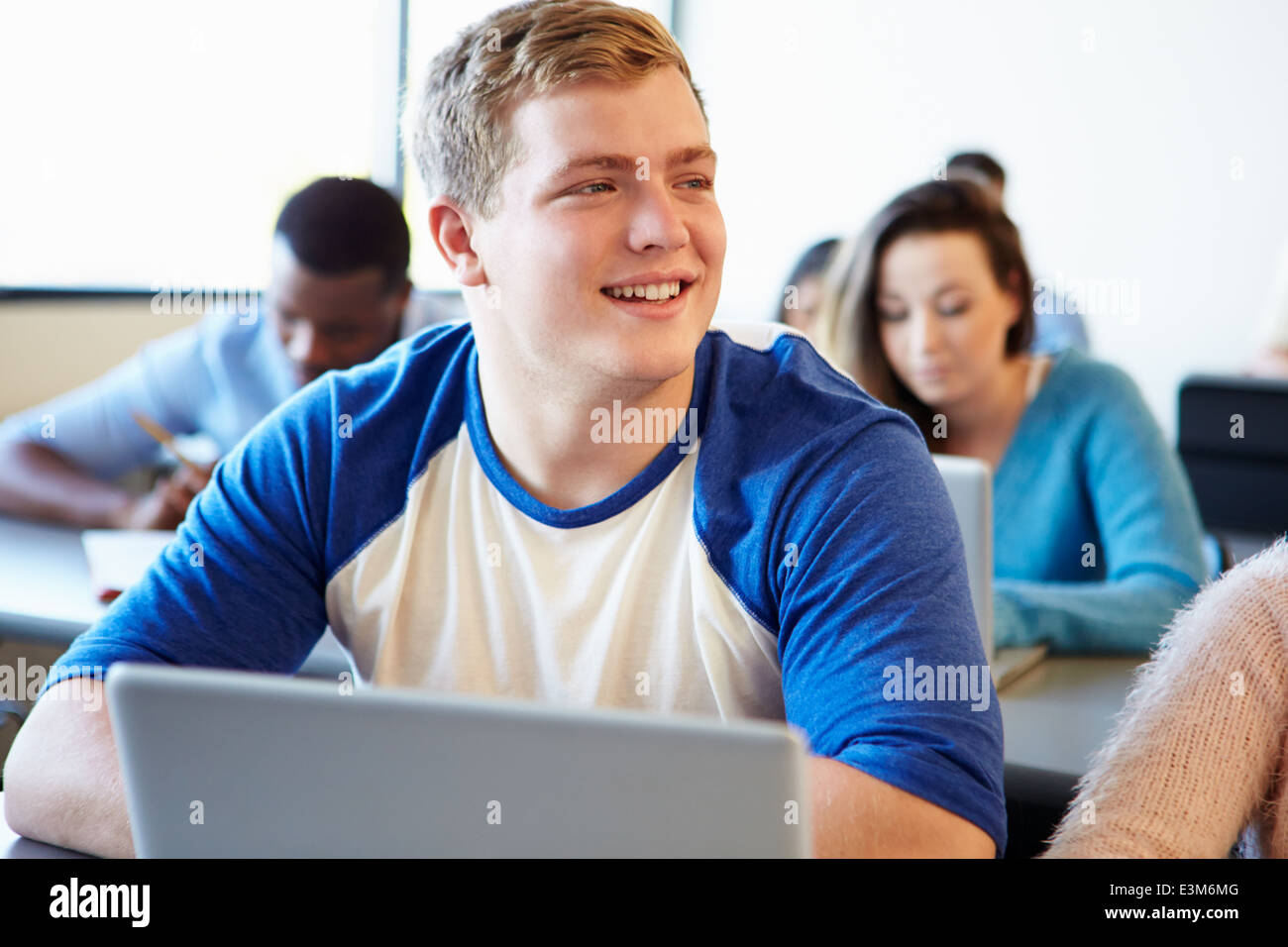 Male University Student Using Laptop In Classroom Stock Photo - Alamy