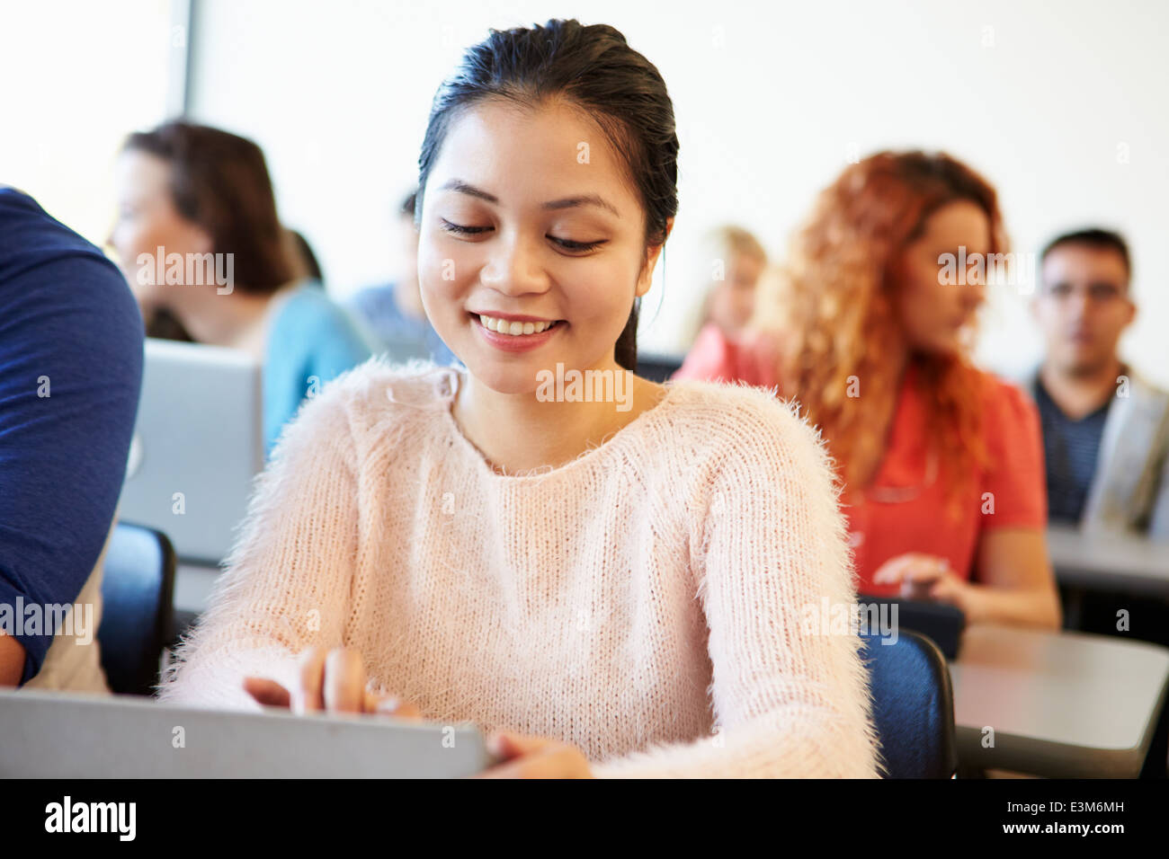 Female University Student Using Digital Tablet In Classroom Stock Photo ...