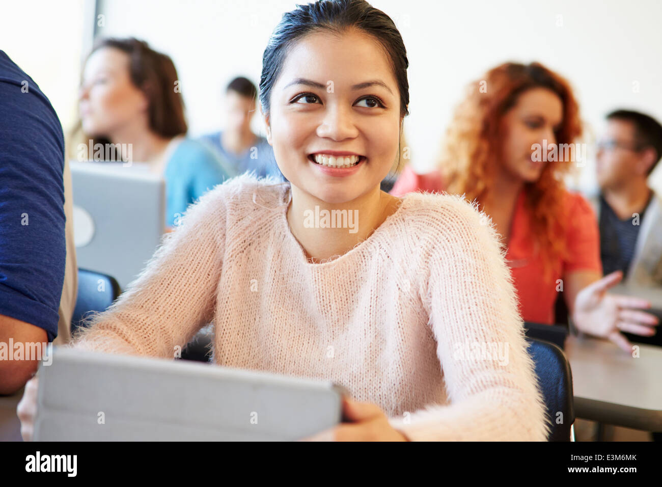 Female University Student Using Digital Tablet In Classroom Stock Photo ...