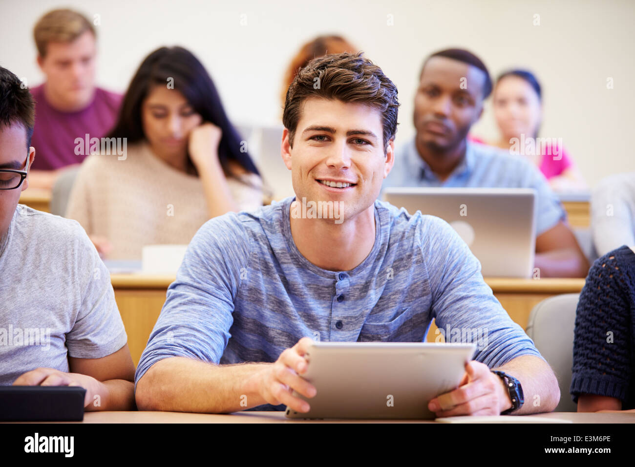 Male University Student Using Digital Tablet In Lecture Stock Photo - Alamy
