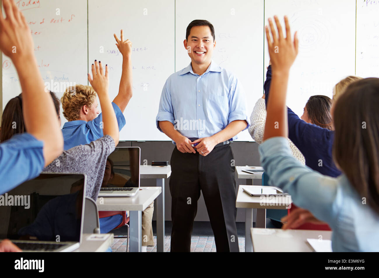Tutor With High School Students In Class Using Laptops Stock Photo - Alamy
