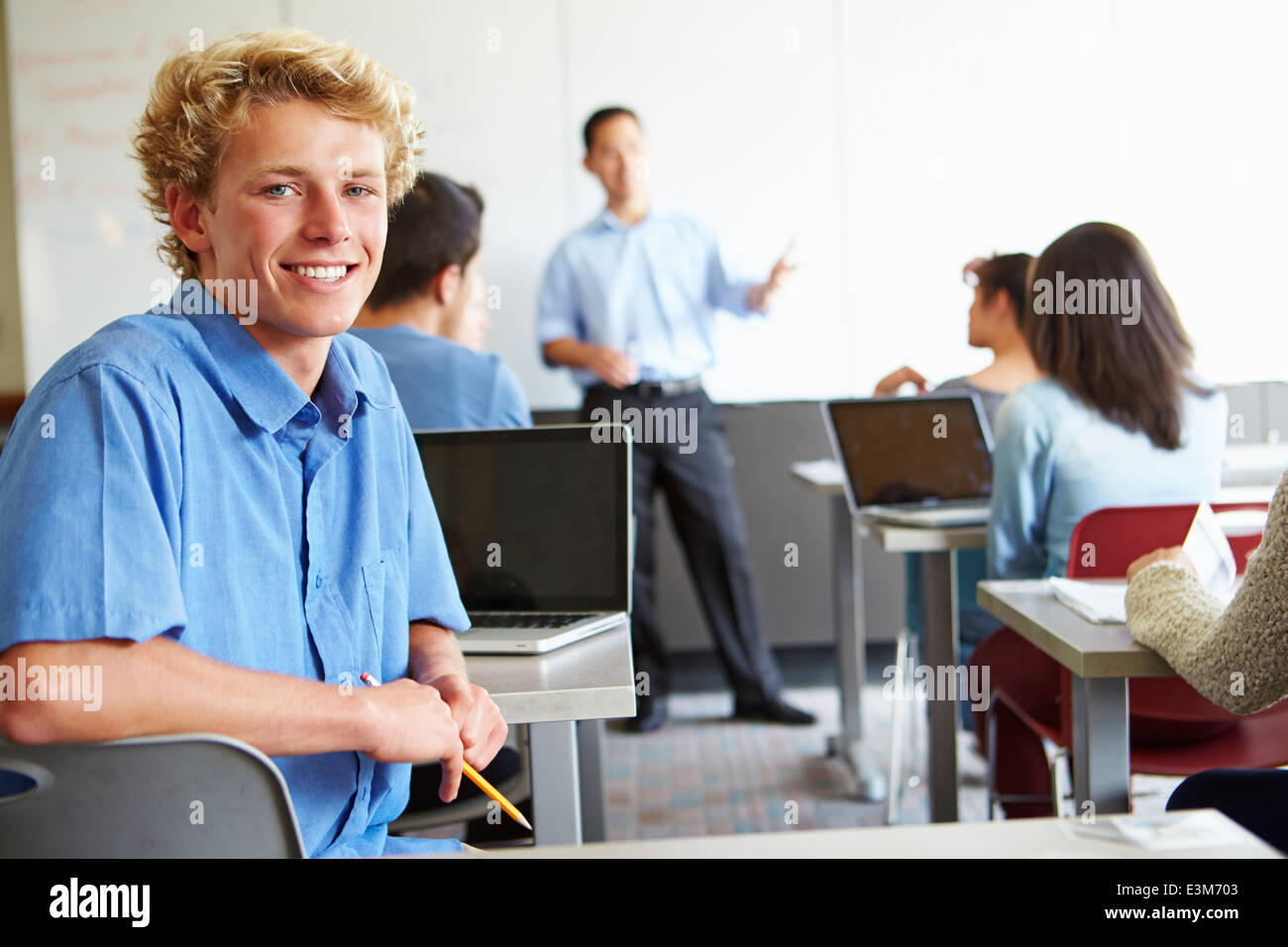Male High School Student Using Laptop In Classroom Stock Photo - Alamy