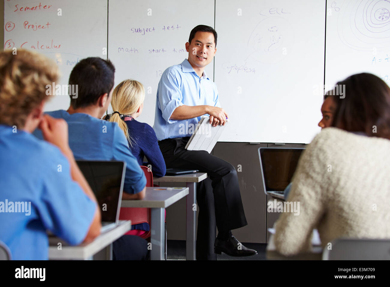 Tutor With High School Students In Class Using Laptops Stock Photo - Alamy