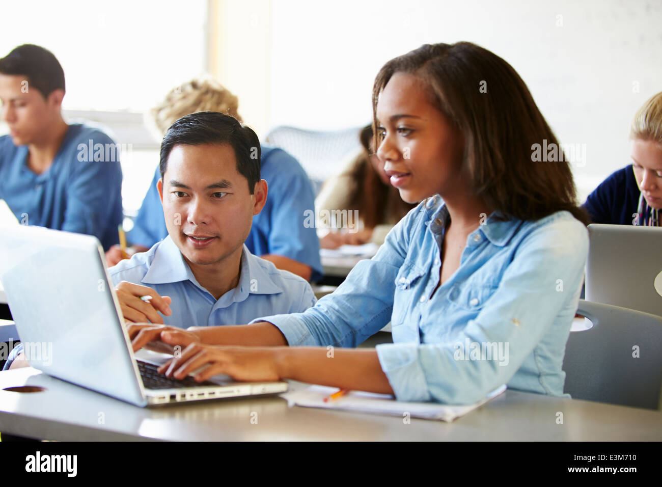 High School Students With Teacher In Class Using Laptops Stock Photo ...