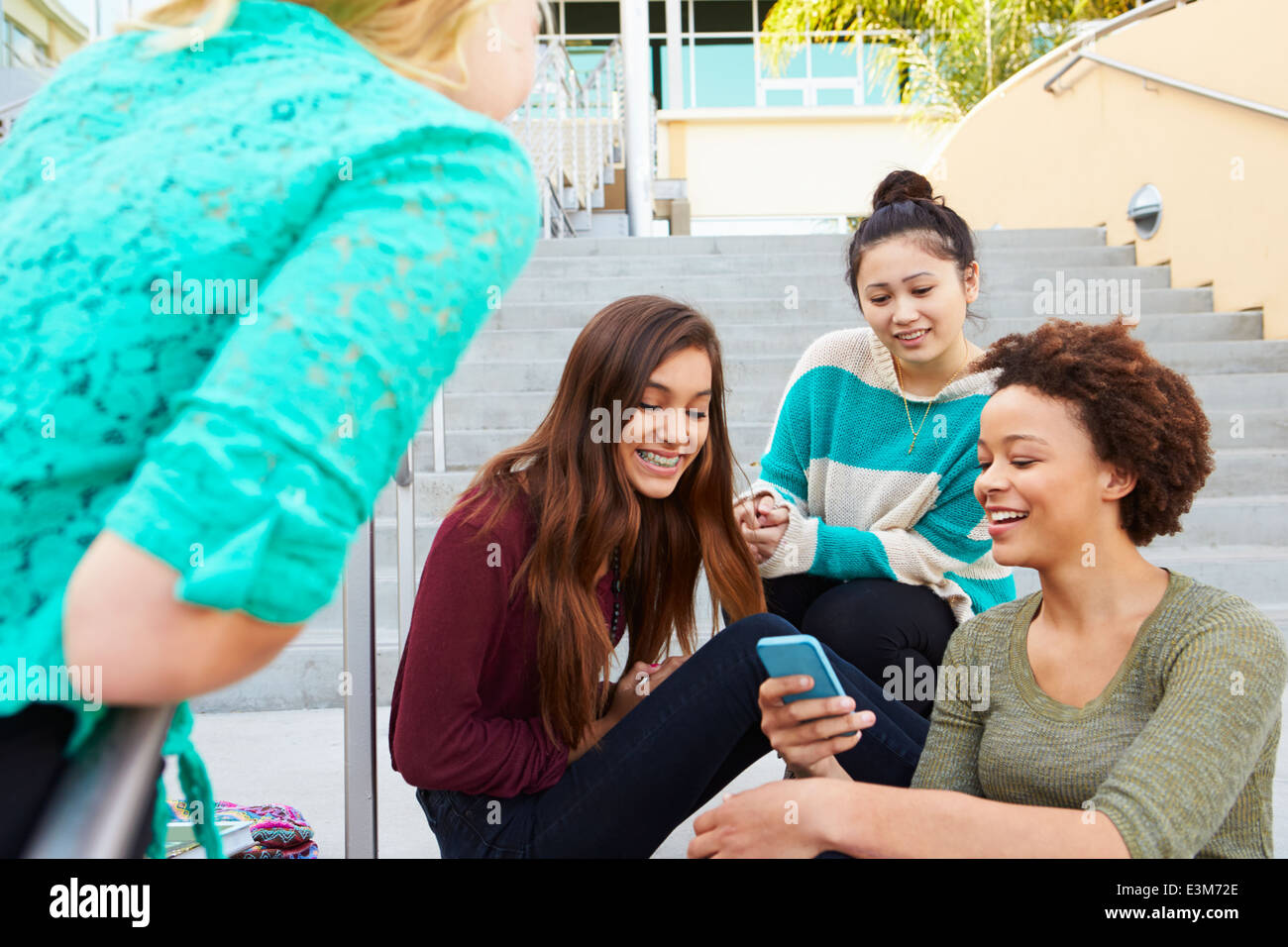 Female High School Students Sitting Outside Building Stock Photo - Alamy