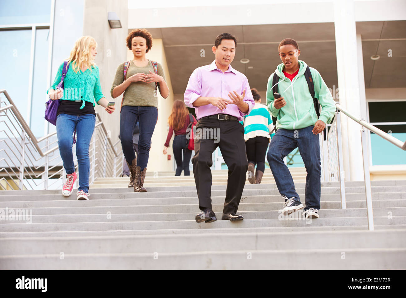 High School Pupils And Teacher On Steps Outside Building Stock Photo ...