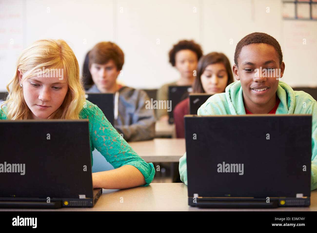 Group Of High School Students In Class Using Laptops Stock Photo - Alamy