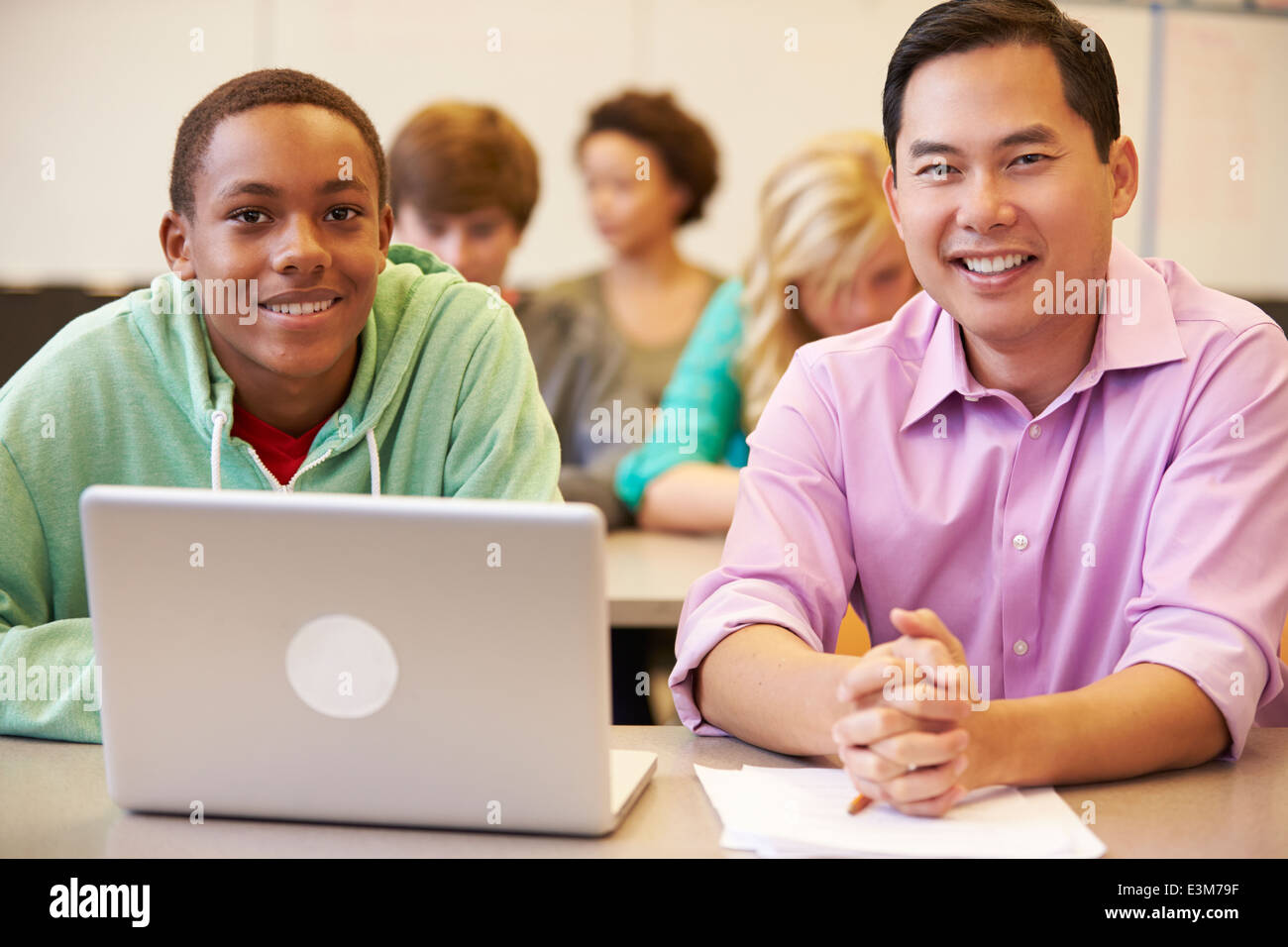 High School Student With Teacher In Class Using Laptop Stock Photo - Alamy