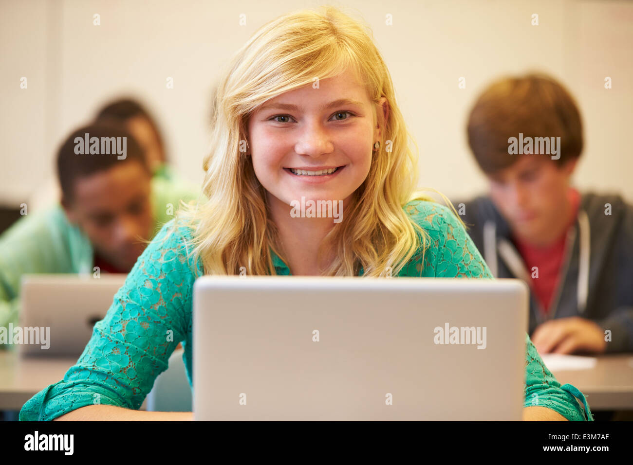 Female High School Student At Desk In Class Using Laptop Stock Photo ...