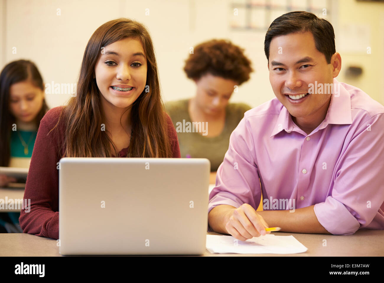 High School Student With Teacher In Class Using Laptop Stock Photo - Alamy