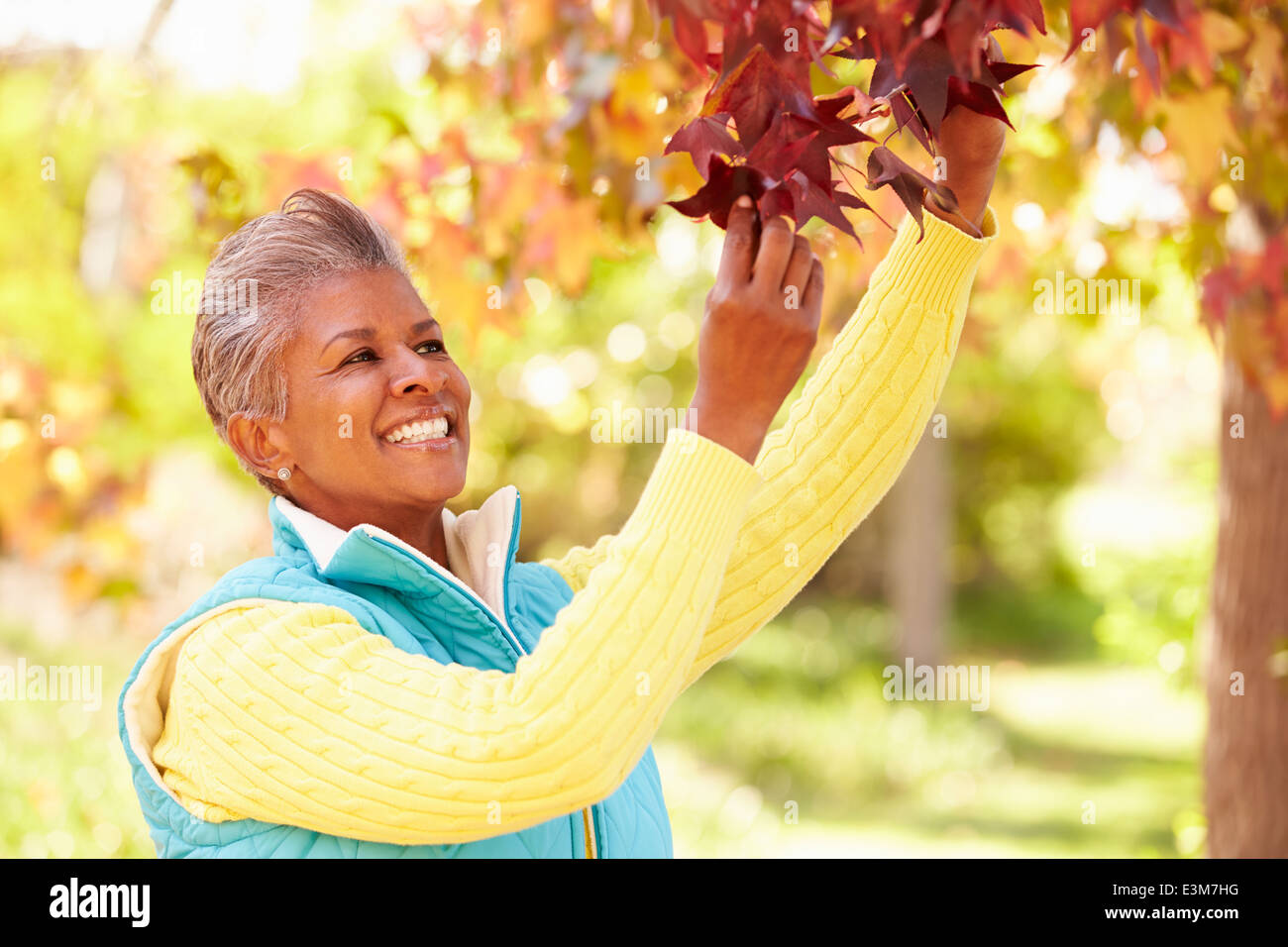 Mature Woman Relaxing In Autumn Landscape Stock Photo - Alamy