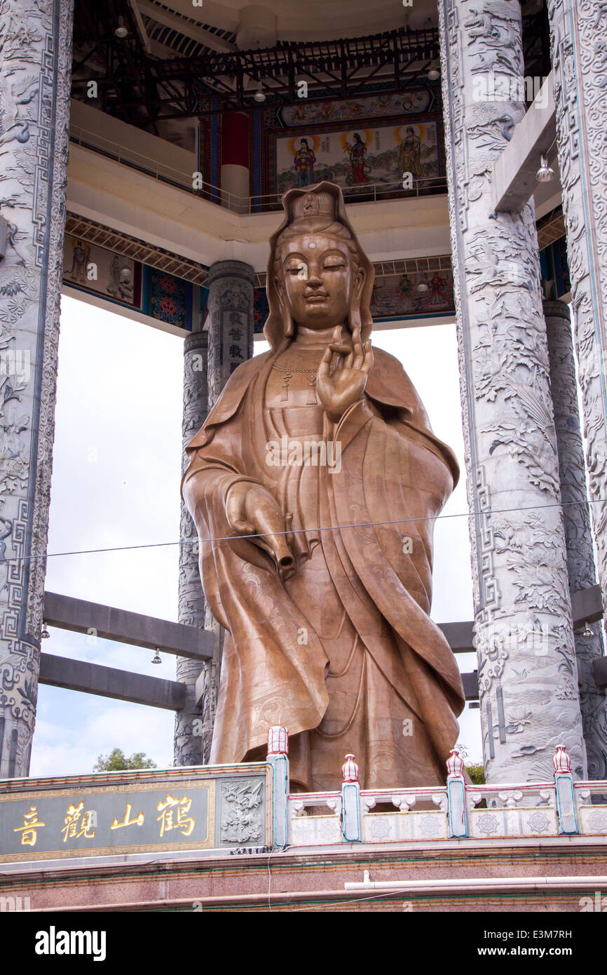 Interior of an ornate Asian temple with statues f deities in recesses ...
