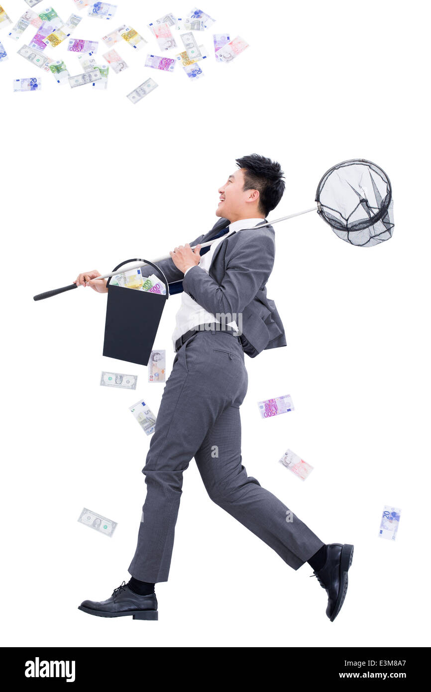 Businessman catching money with butterfly net Stock Photo - Alamy