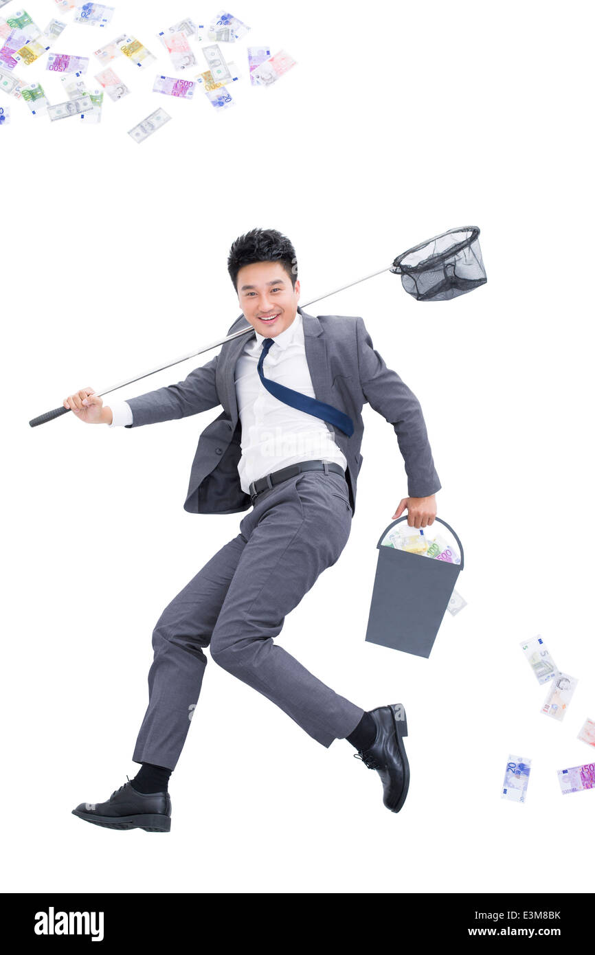 Businessman catching money with butterfly net Stock Photo - Alamy