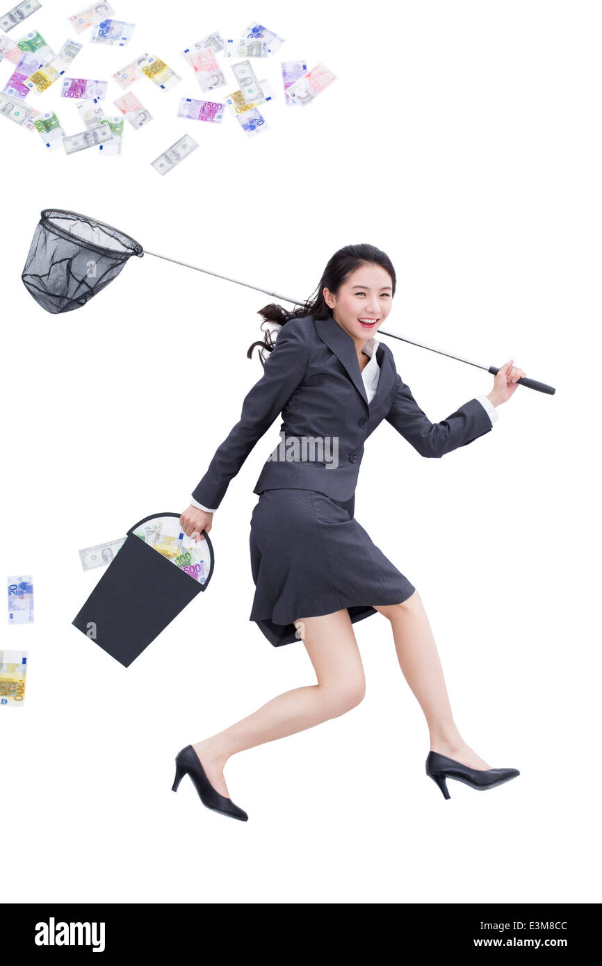 Businesswoman catching money with butterfly net Stock Photo - Alamy