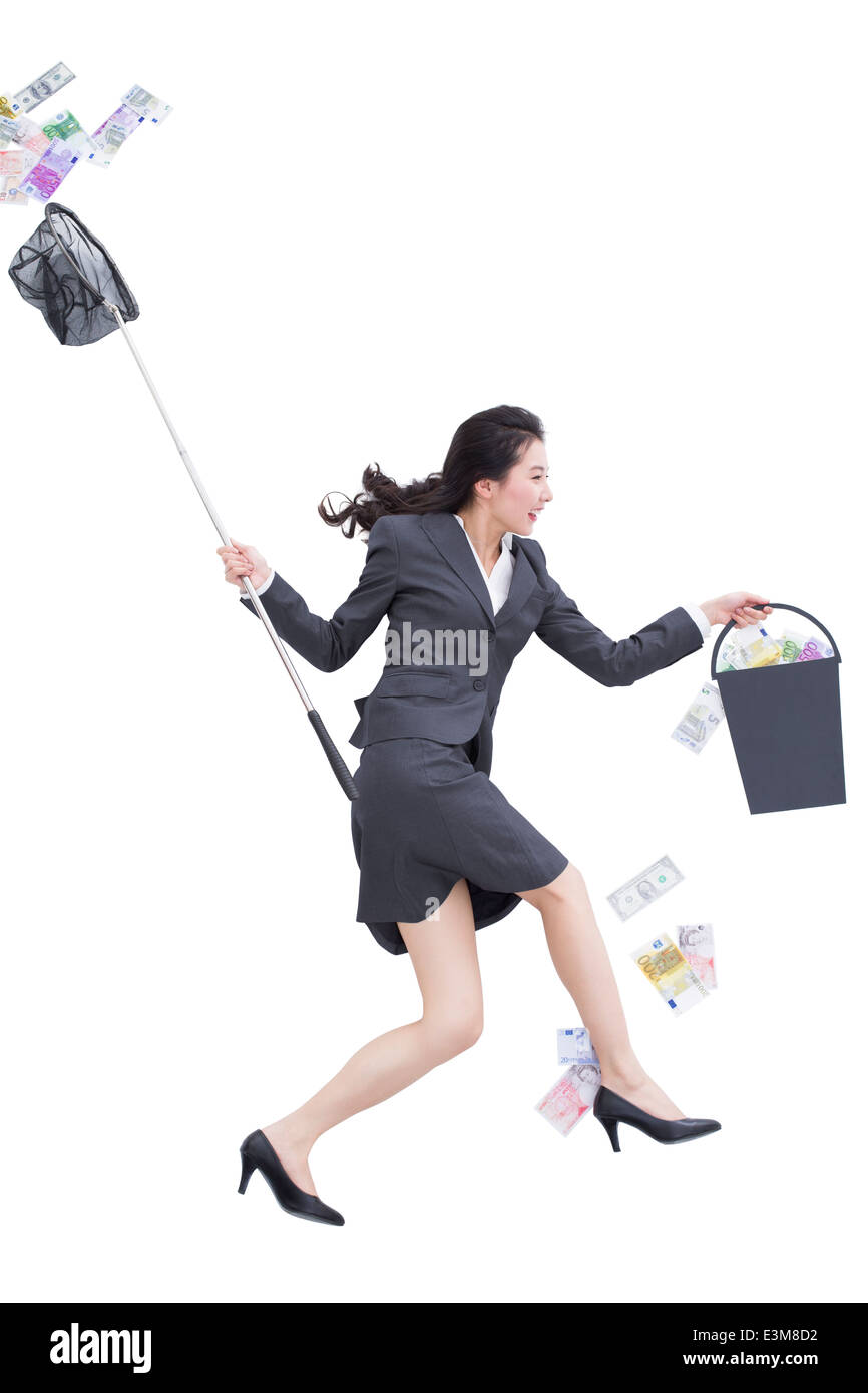 Businesswoman catching money with butterfly net Stock Photo - Alamy