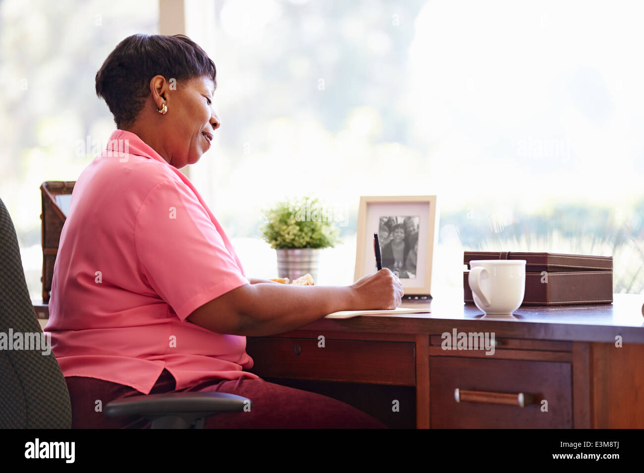 Adult female sitting writing hi-res stock photography and images - Alamy