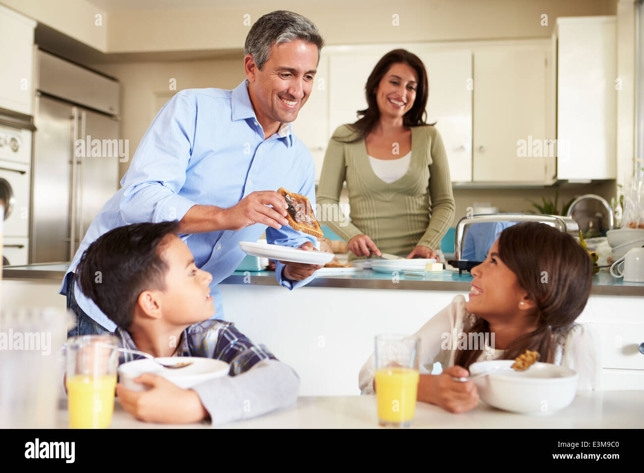 Hispanic Family Eating Breakfast At Home Together Stock Photo - Alamy