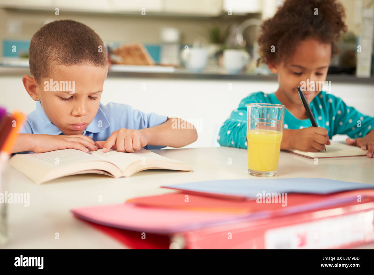 Children Doing Homework Together At Table Stock Photo - Alamy