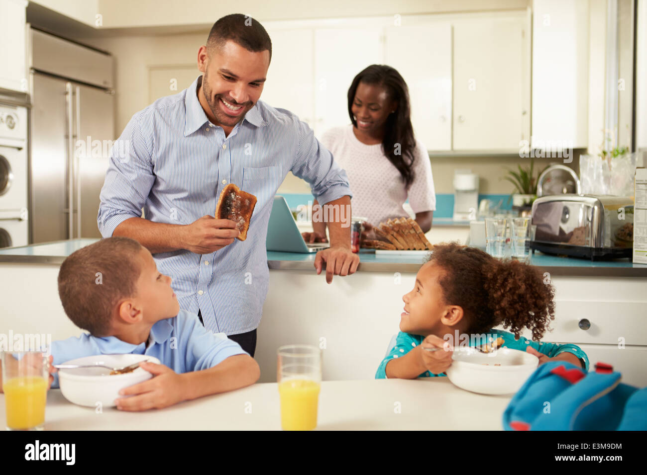 Family Eating Breakfast At Home Together Stock Photo - Alamy