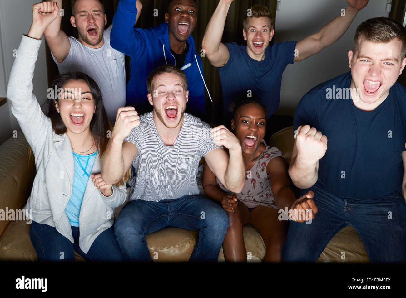 Group Of Friends Watching Television At Home Together Stock Photo - Alamy