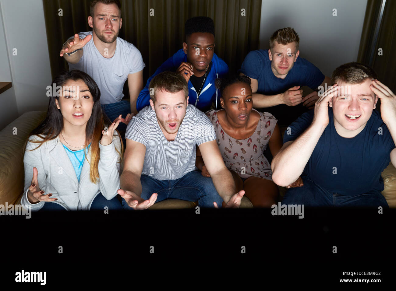 Group Of Friends Watching Television At Home Together Stock Photo - Alamy