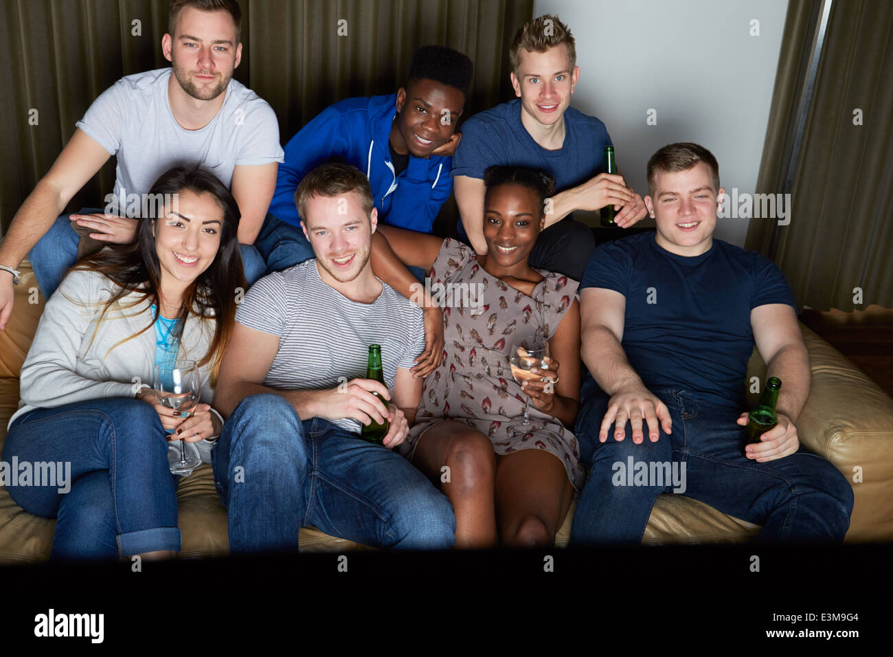Group Of Friends Watching Television At Home Together Stock Photo - Alamy
