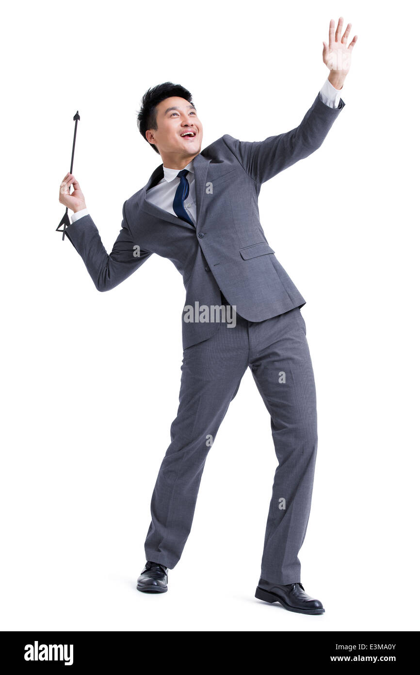 Happy businessman with arrow in hand Stock Photo - Alamy