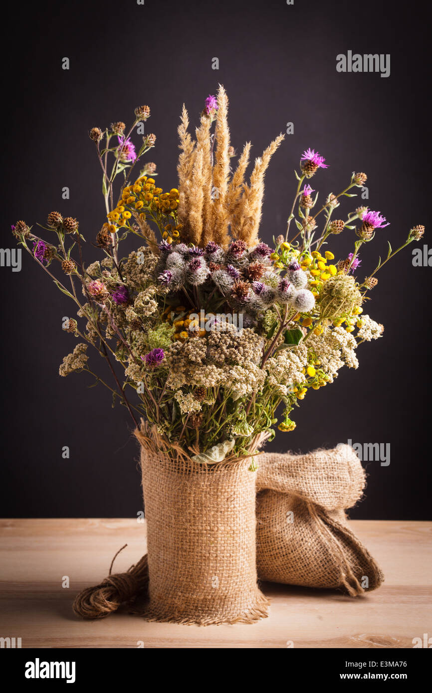 Wildflowers in the bagging vase on a table Stock Photo - Alamy