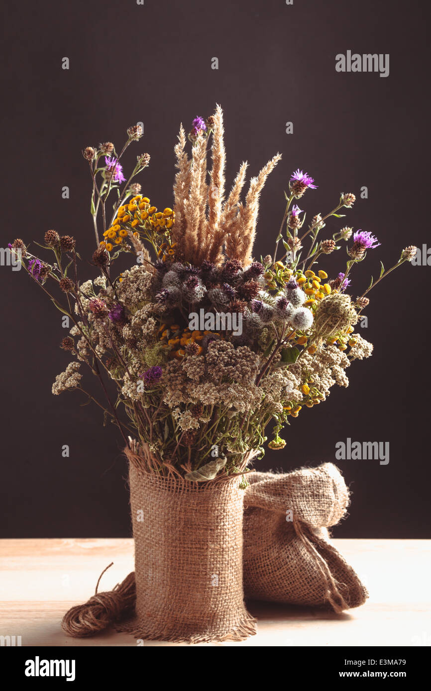 Wildflowers in the bagging vase on a table Stock Photo - Alamy