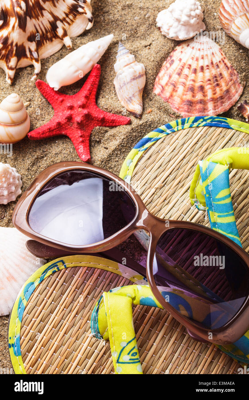 Seashells on the sand, glasses and thongs - symbols of sea rest Stock ...