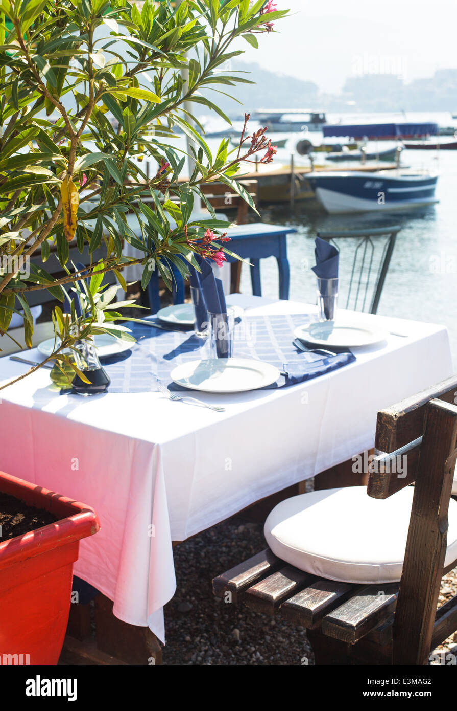 Serving table in the outdoor restaurant on the seaside Stock Photo - Alamy