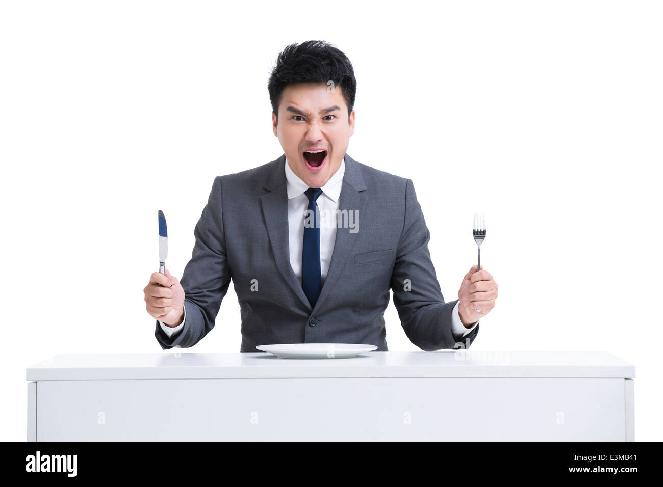 Angry businessman having fast food Stock Photo - Alamy