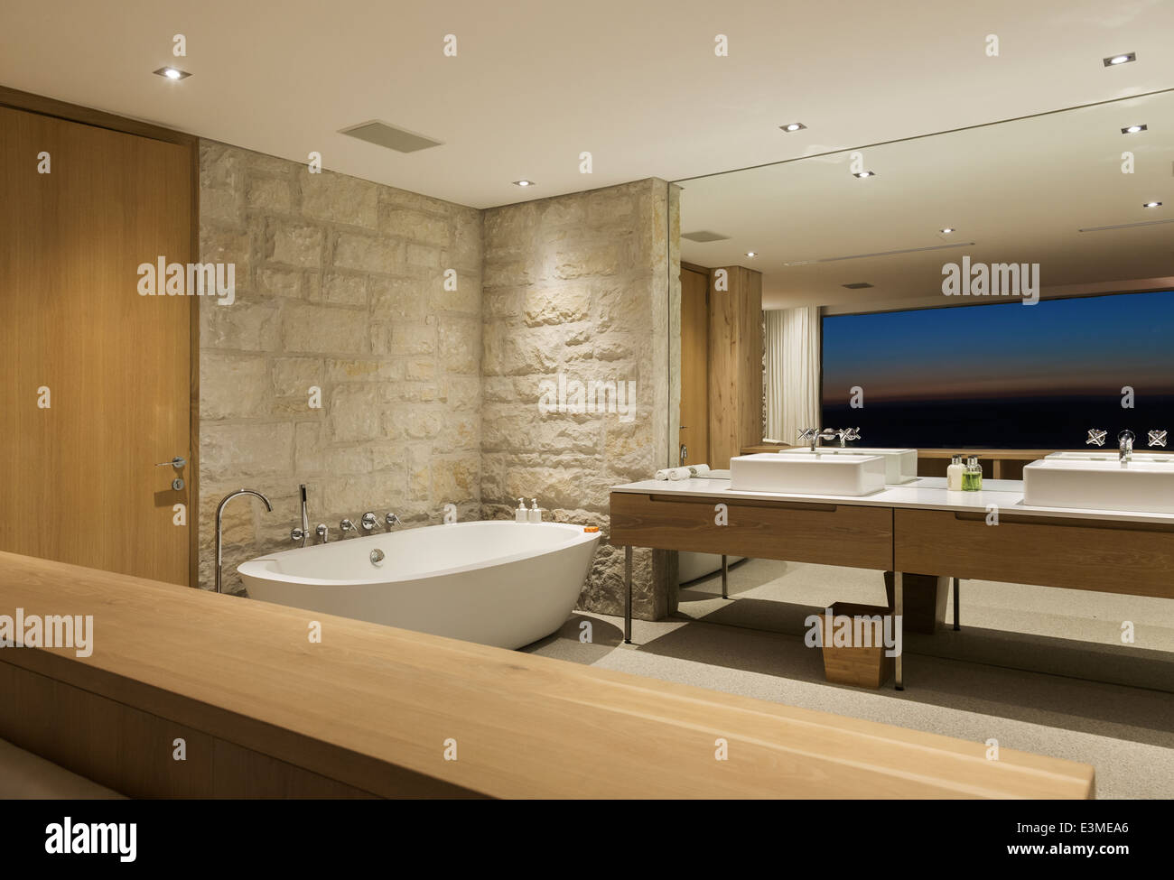 Modern bathroom with soaking tub at night Stock Photo - Alamy