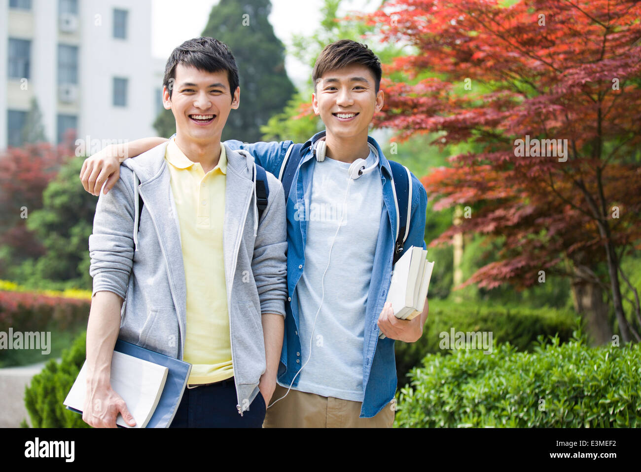Happy college students on campus Stock Photo - Alamy