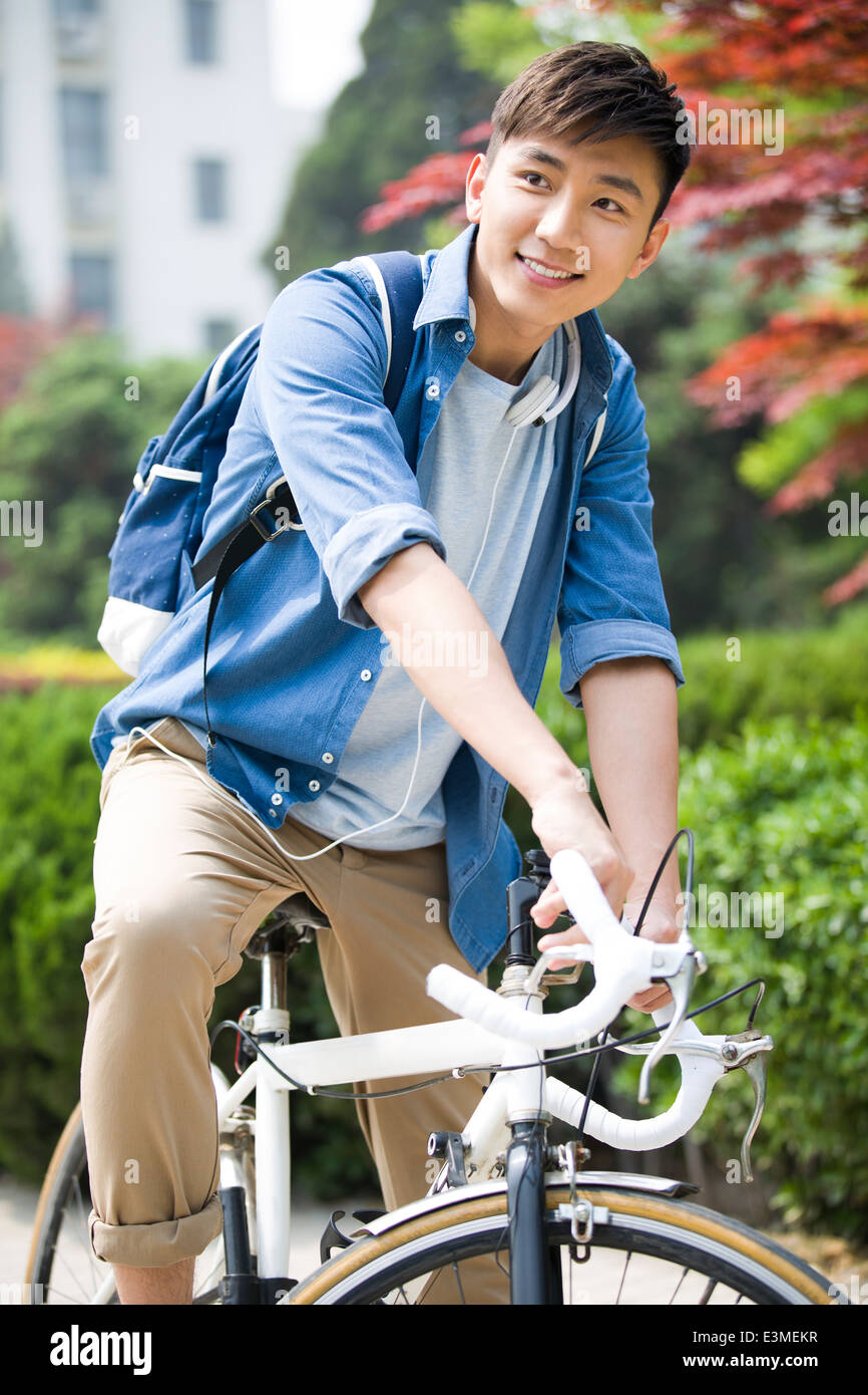 Male college student with bicycle Stock Photo - Alamy