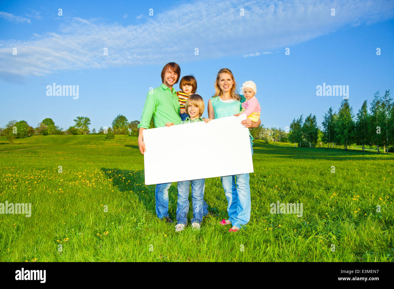 Happy family holds white square paper format Stock Photo - Alamy