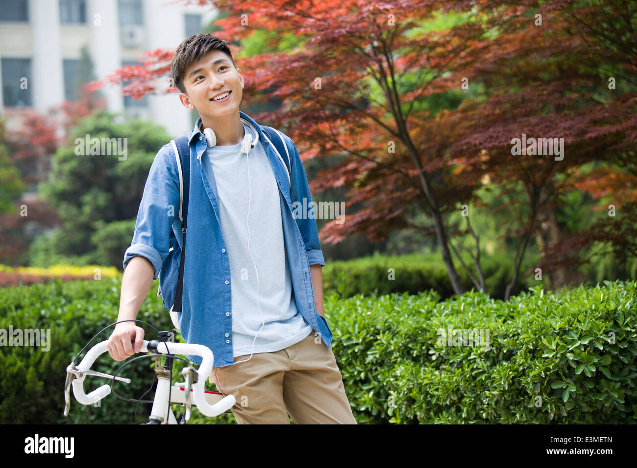 Male college student with bicycle Stock Photo - Alamy