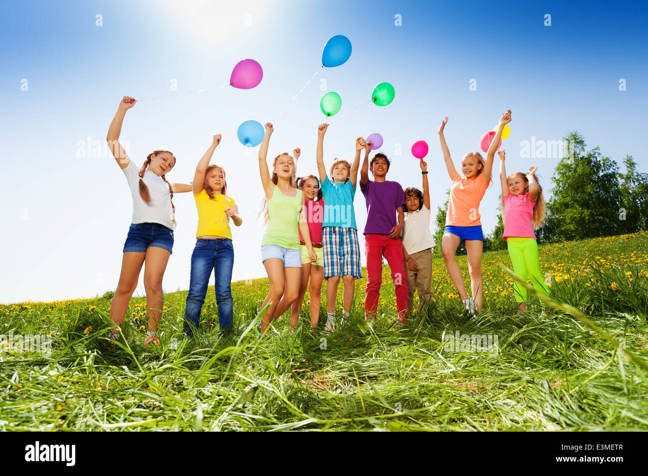 Children jumping in air in park hi-res stock photography and images - Alamy