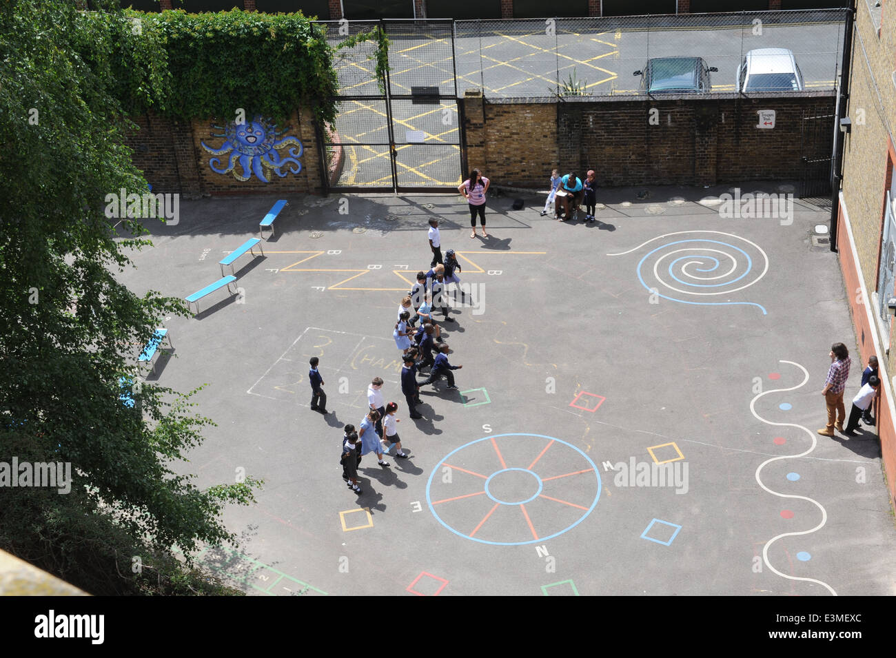 School children playing in a school playground in an inner city london ...